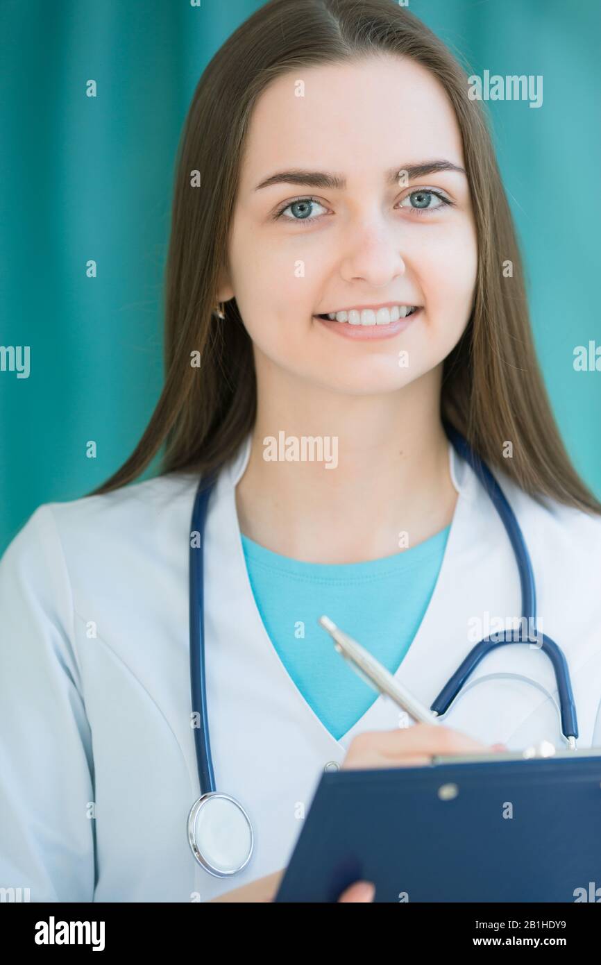 Medical doctor holding folder for notes in hands Stock Photo - Alamy