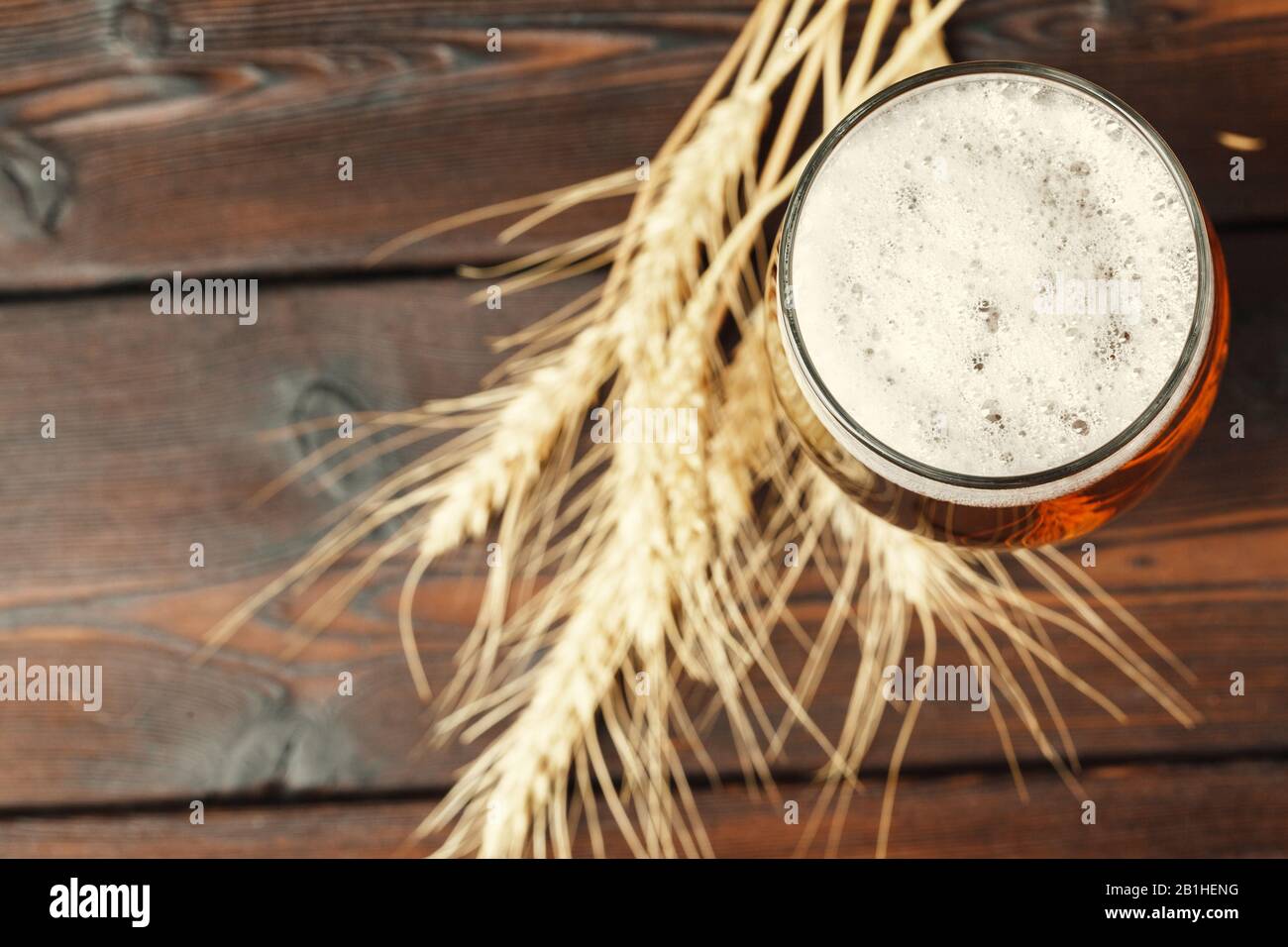 Glass beer on wood background. Creative photo Stock Photo - Alamy