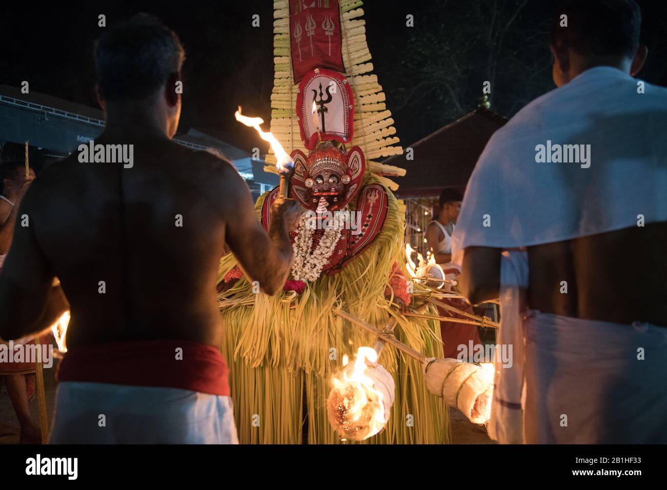 Theyyam performer, surrounded by torches, dances a popular ritual form ...