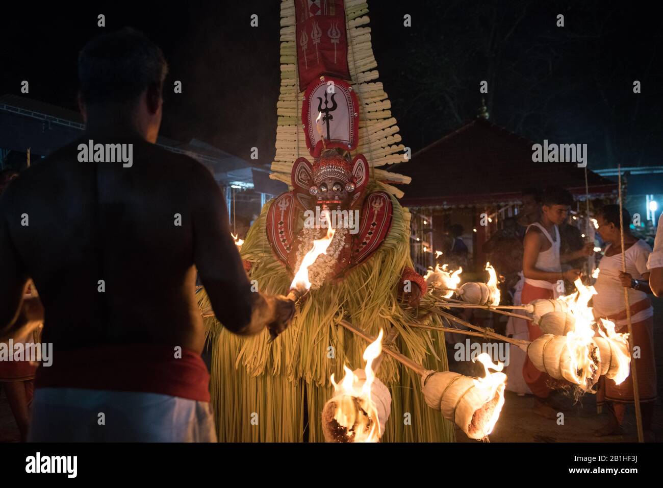Theyyam performer, surrounded by torches, dances a popular ritual form ...