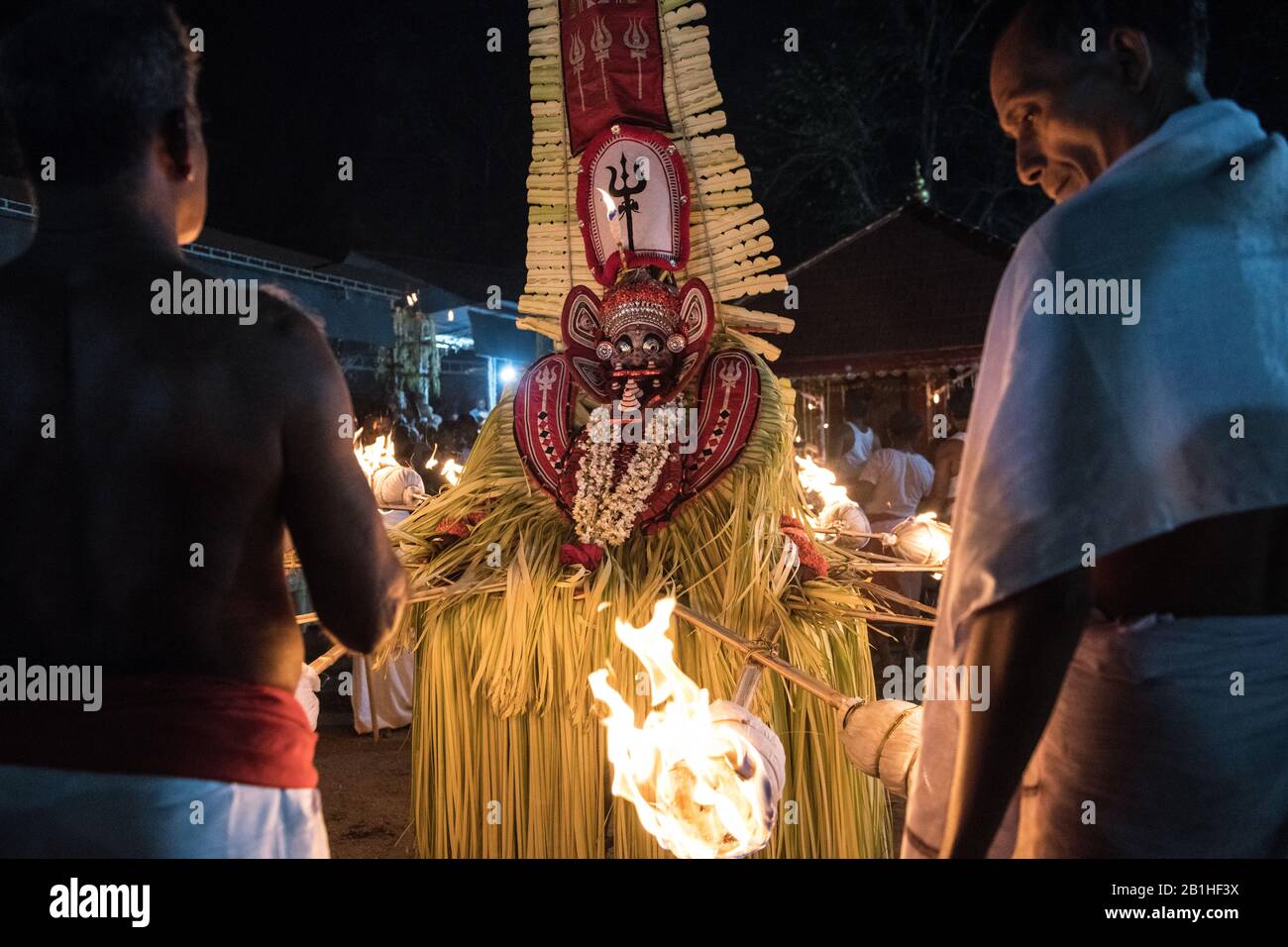 Theyyam performer, surrounded by torches, dances a popular ritual form ...