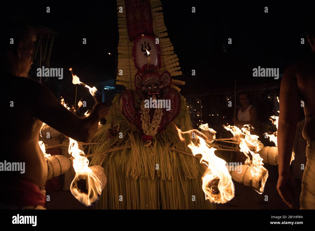 Theyyam performer, surrounded by torches, dances a popular ritual form ...