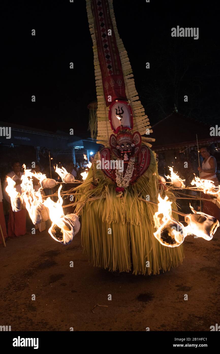 Theyyam performer, surrounded by torches, dances a popular ritual form ...