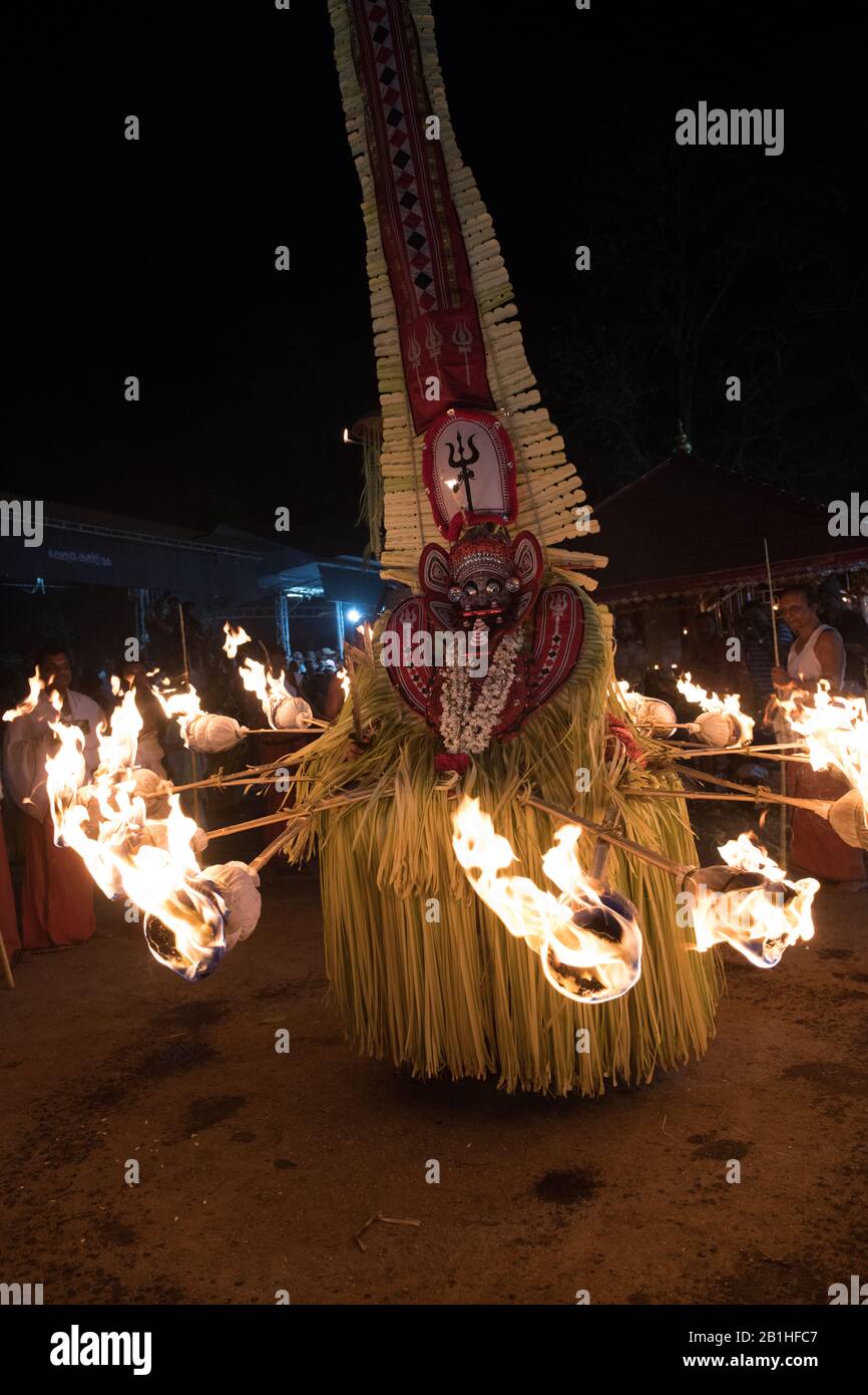 Theyyam performer, surrounded by torches, dances a popular ritual form ...