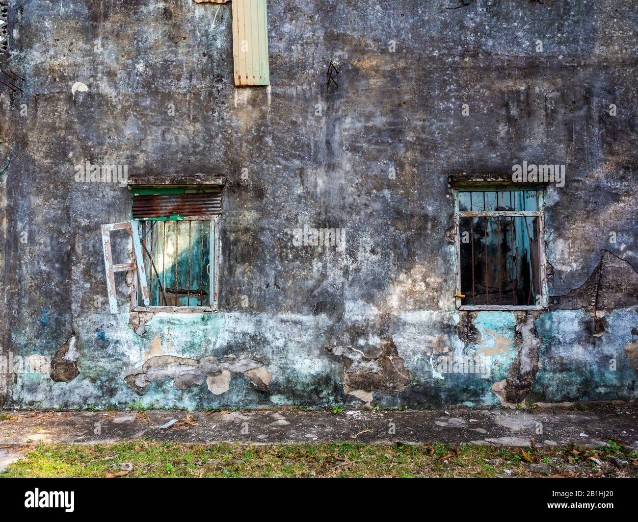 Old grunge concrete wall of abandoned building with decayed windows ...