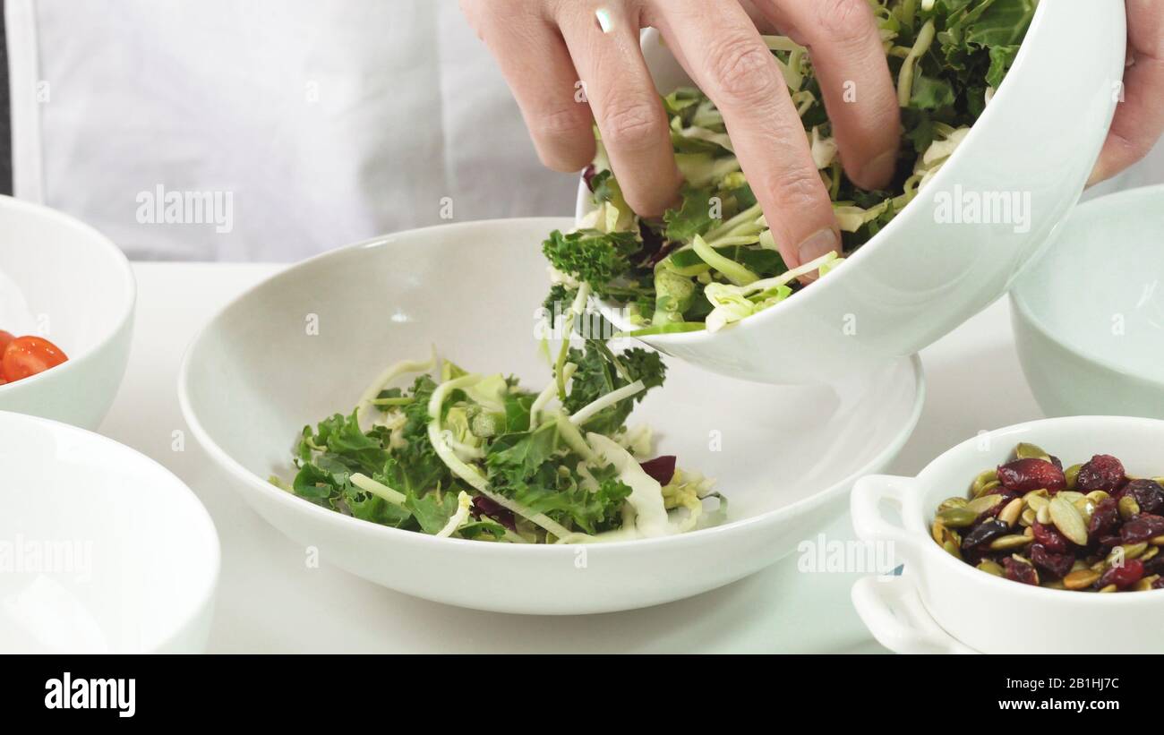 Preparation of vegetable salad step by step. Woman puts fresh green ...