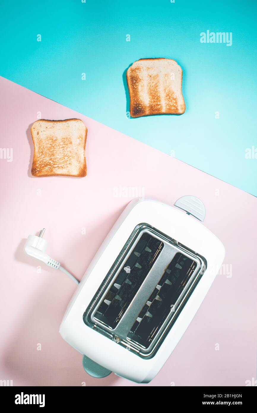 Toaster and bread slices Cooking bread in a toaster on a pink ...