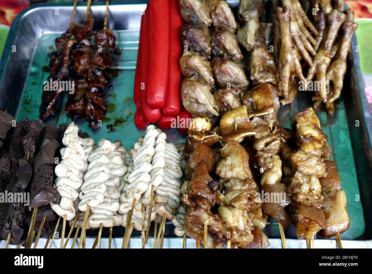 Photo of assorted chicken and pork innards and hotdog in barbecue ...