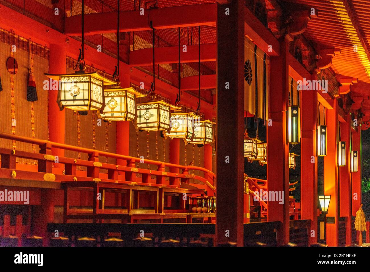A row of lanterns decorating the Fushimi Inari shrine at night, Kyoto ...