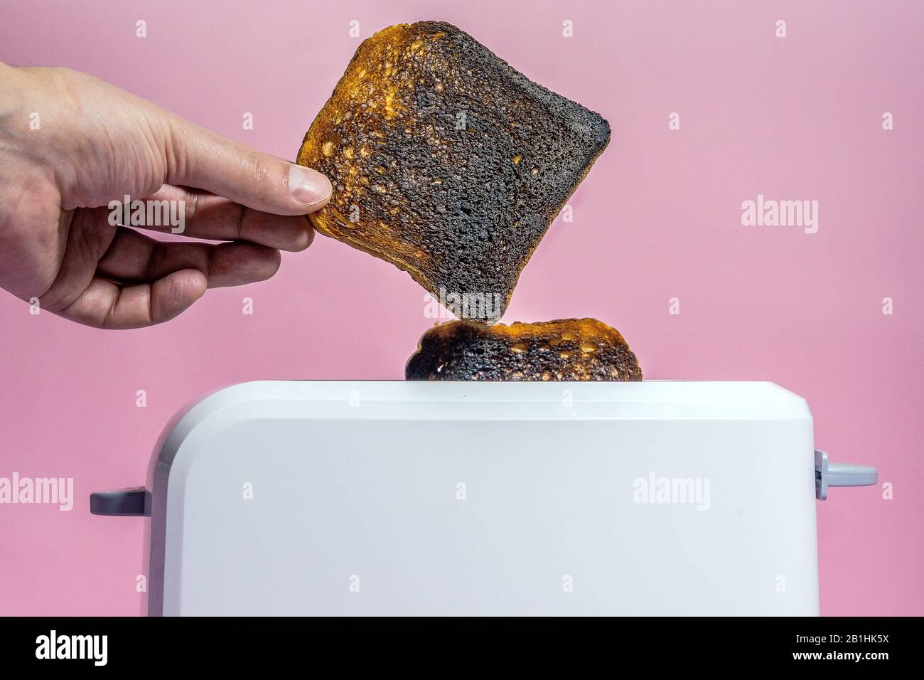 Burning Toast cooking Breakfast. black bread burned Stock Photo - Alamy