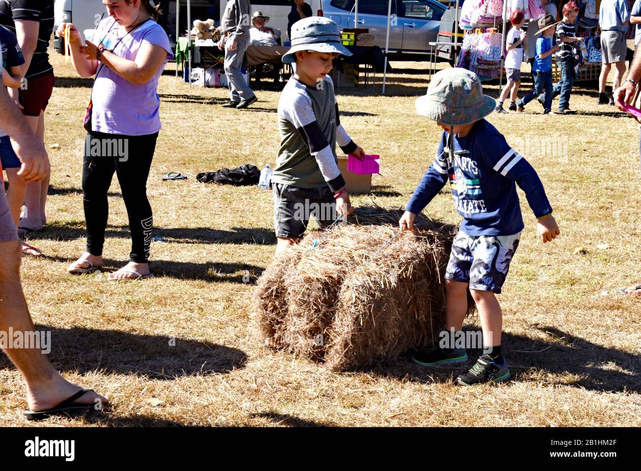 Children competing in throw the hay bale game hi-res stock photography ...