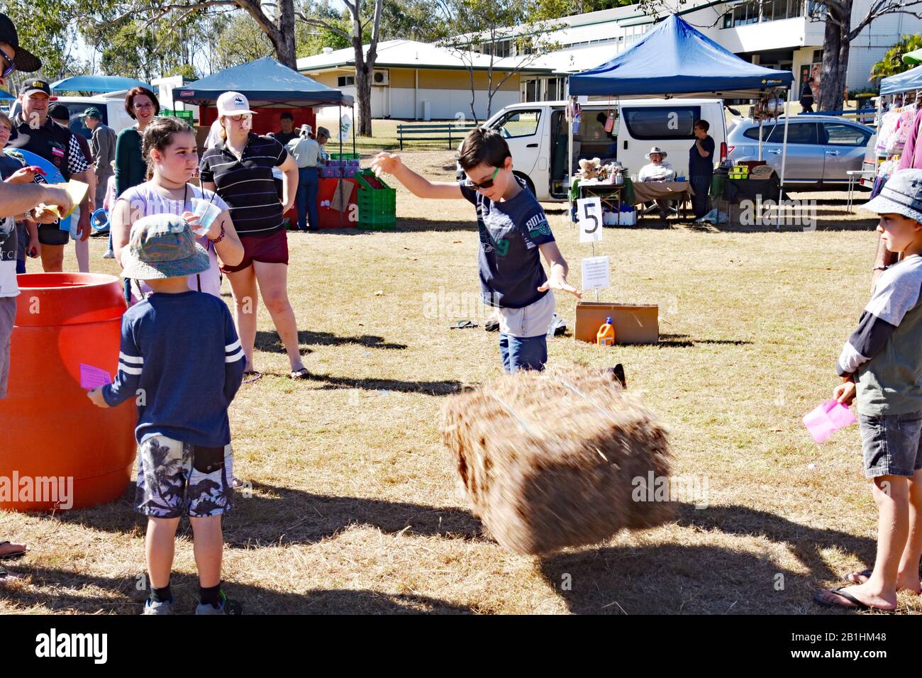 Children Competing In Throw The Hay Bale Game High Resolution Stock ...