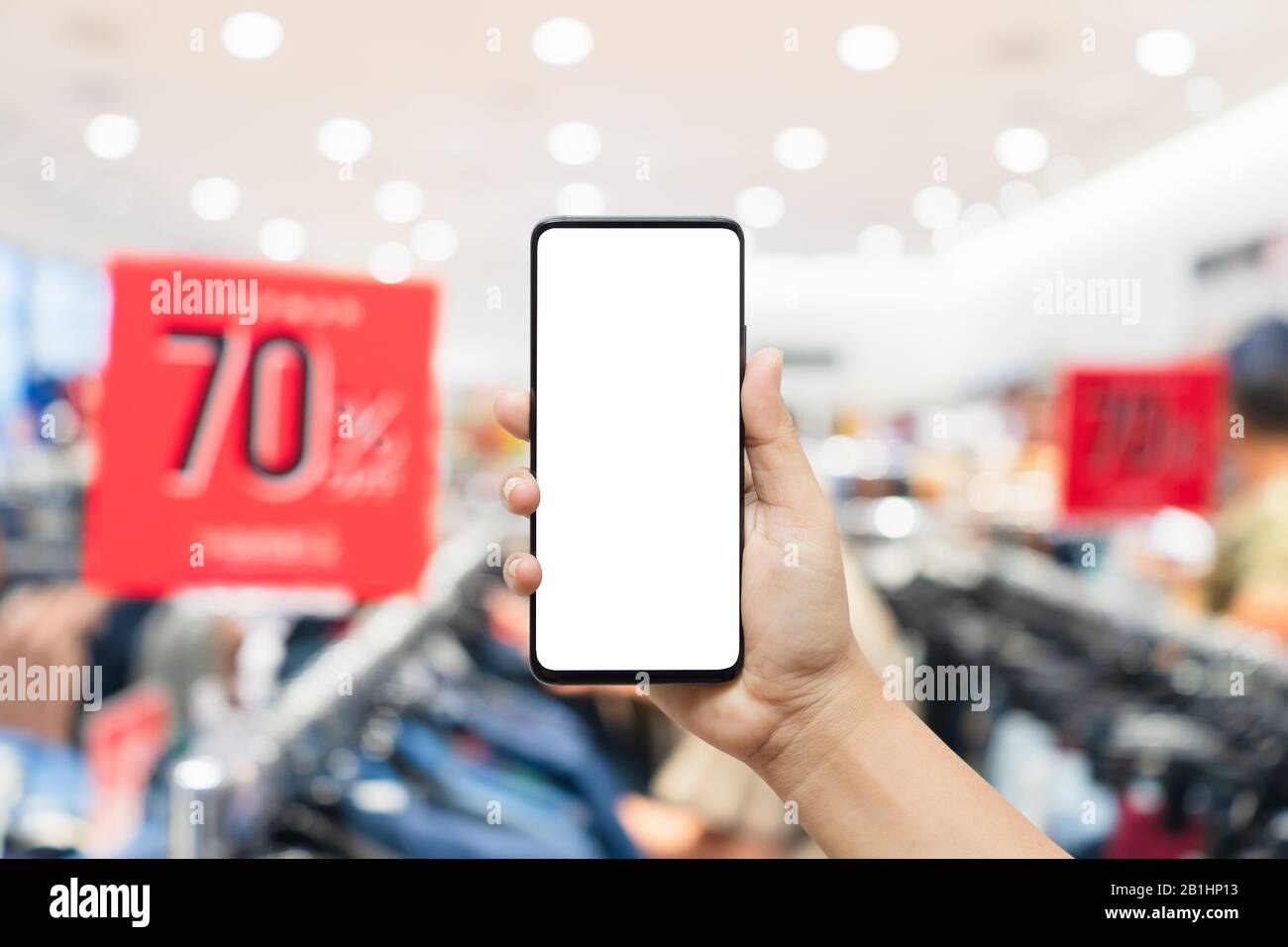 Abstract mockup mobile phone with blurred clothing store and discount ...