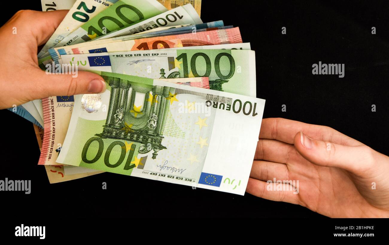 euro currency, european uninon money, hand giving euros cash on the ...