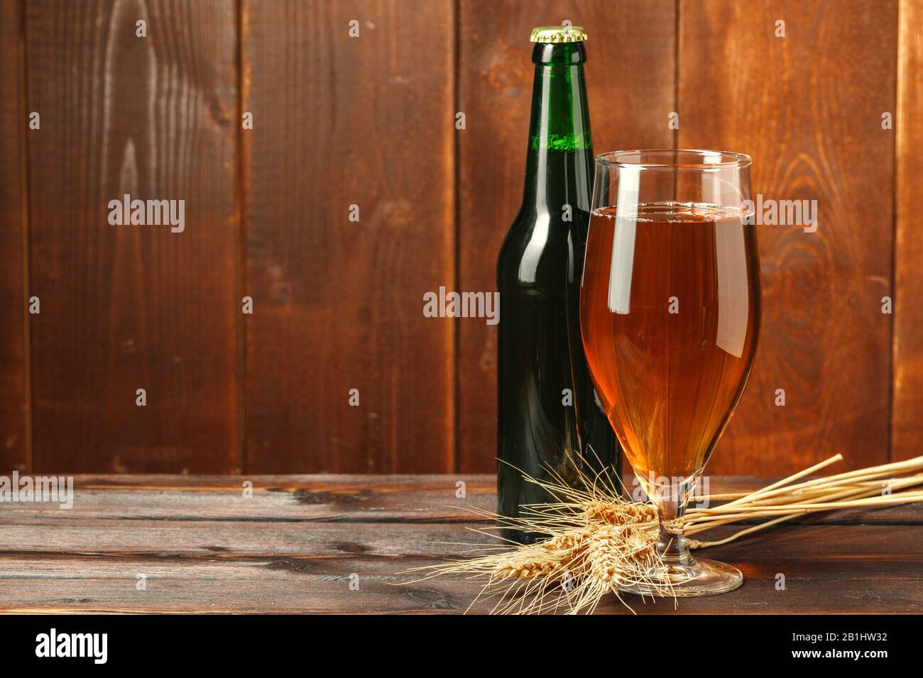Glass beer on wood background. Creative photo Stock Photo - Alamy
