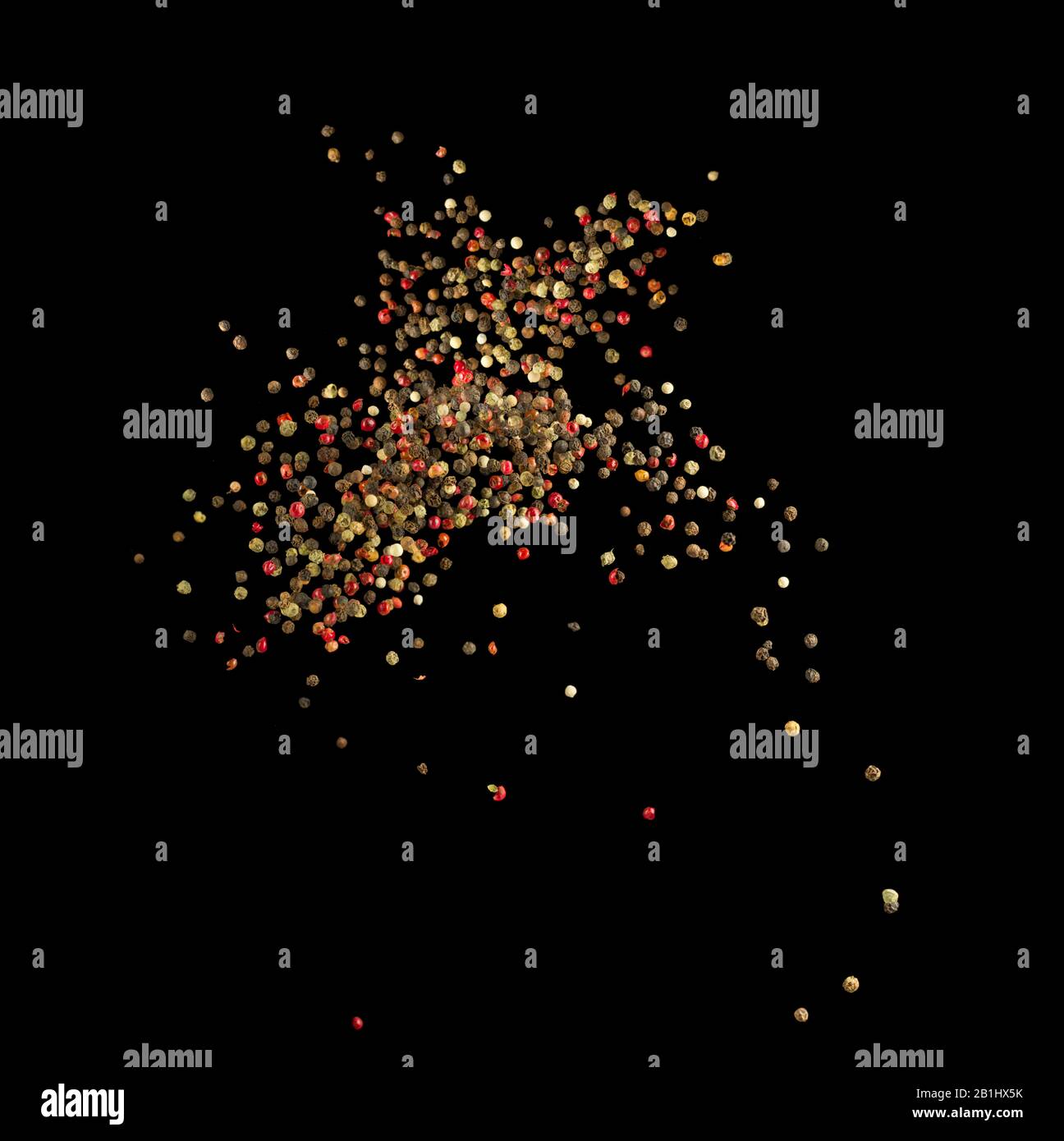 Whole coloured pepper spice flying in the air. Zero gravity concept ...