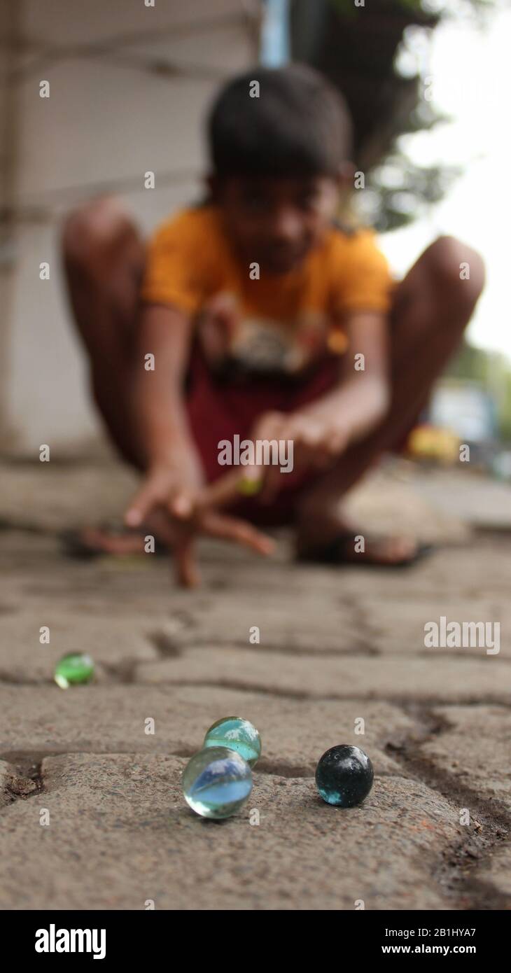 Children playing marbles on street hi-res stock photography and images ...