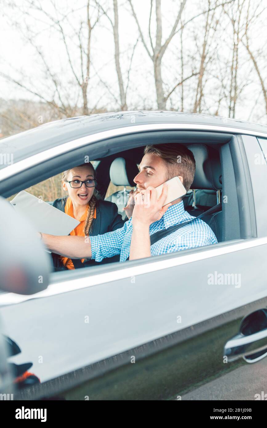 Driving instructor being mad at student using his telephone while ...