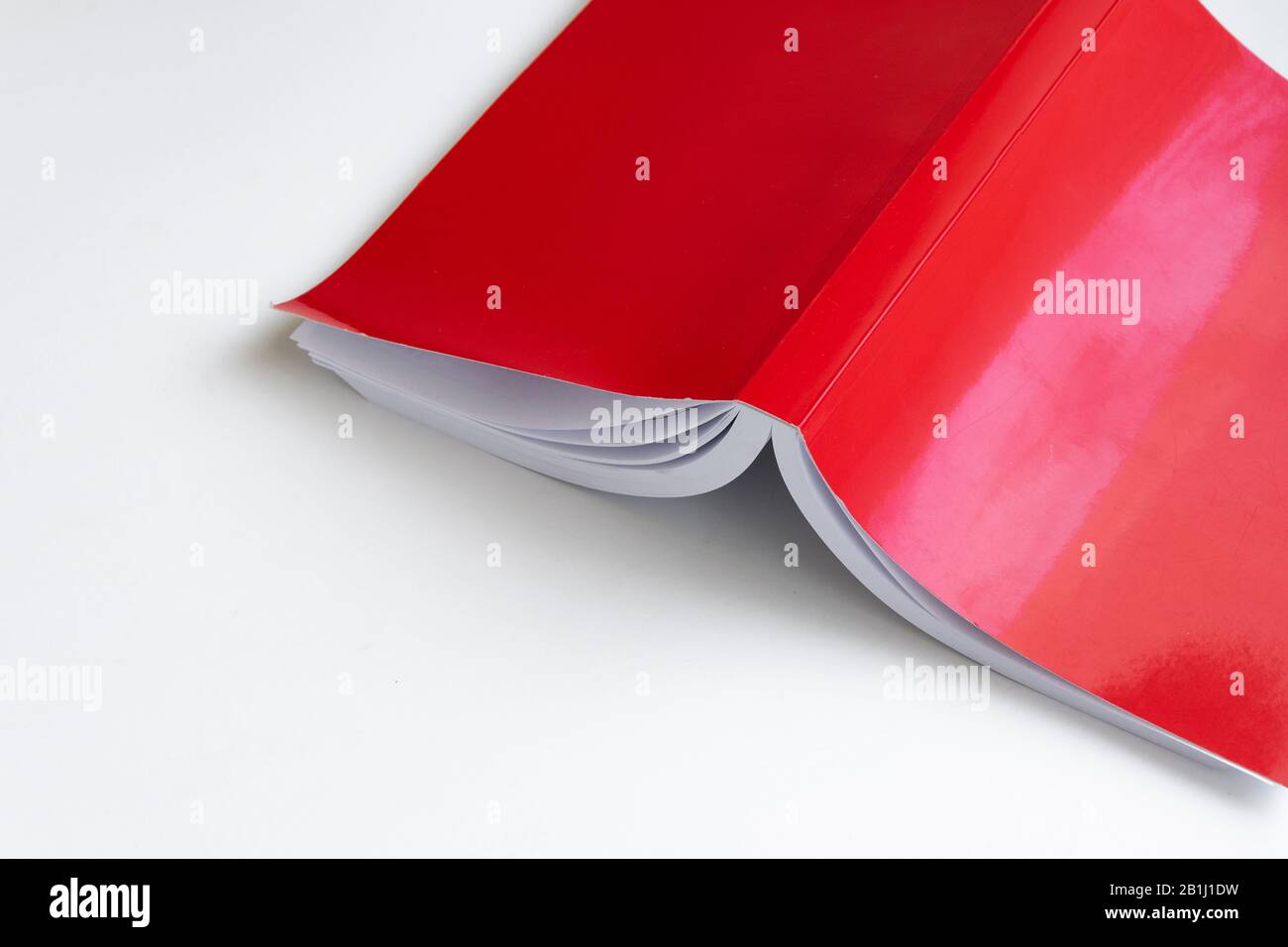 Red book on white background Stock Photo - Alamy