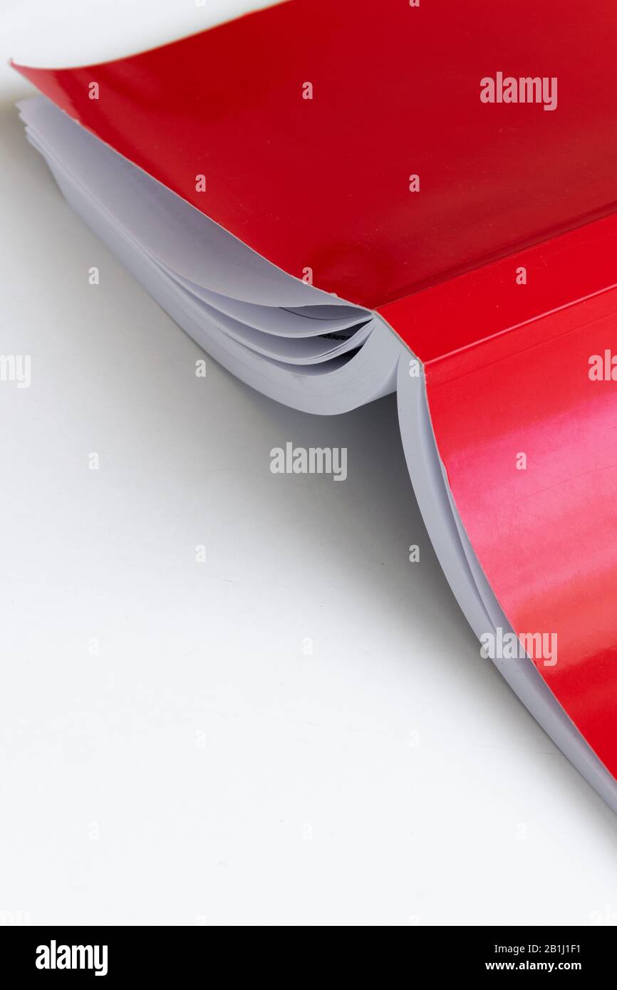 Red book on white background Stock Photo - Alamy