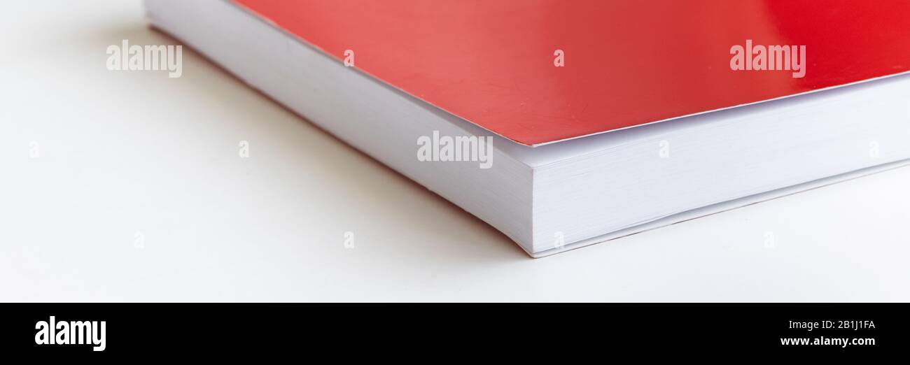 Red book on white background Stock Photo - Alamy