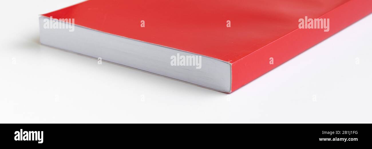 Red book on white background Stock Photo - Alamy