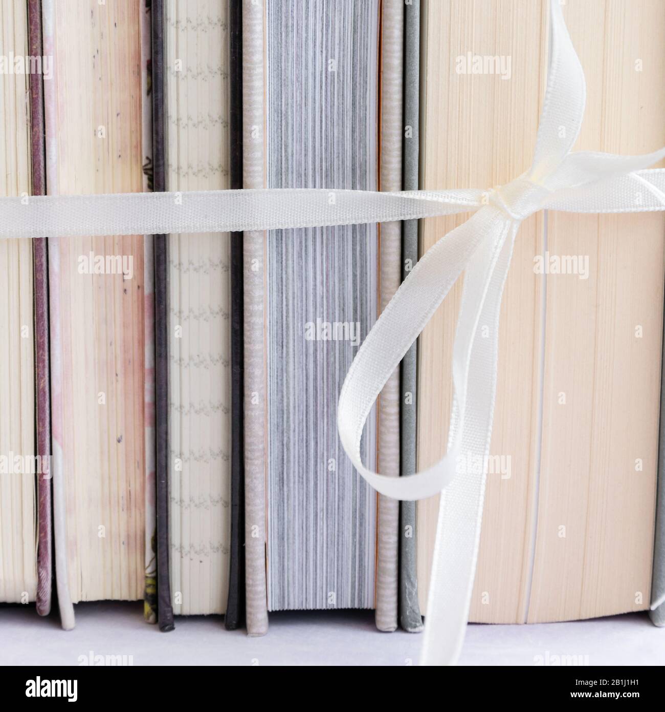 Stack of books tied with a bow Stock Photo - Alamy
