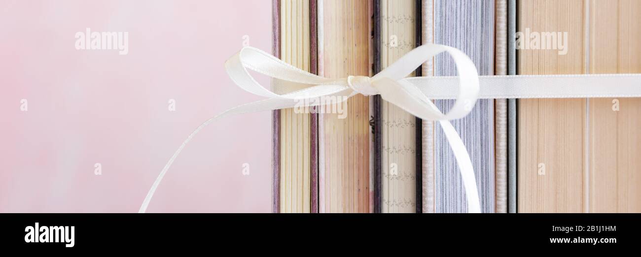 Stack of books tied with a bow Stock Photo - Alamy
