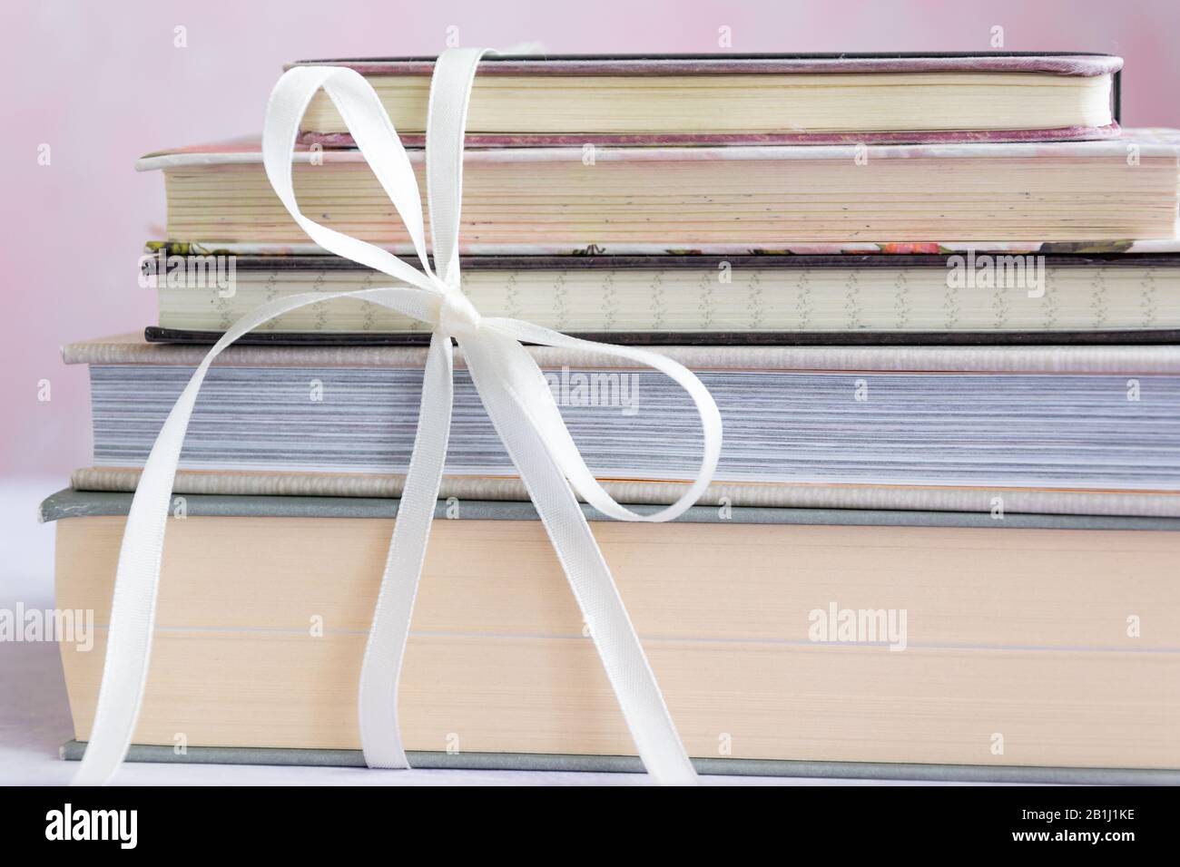 Stack of books tied with a bow Stock Photo - Alamy