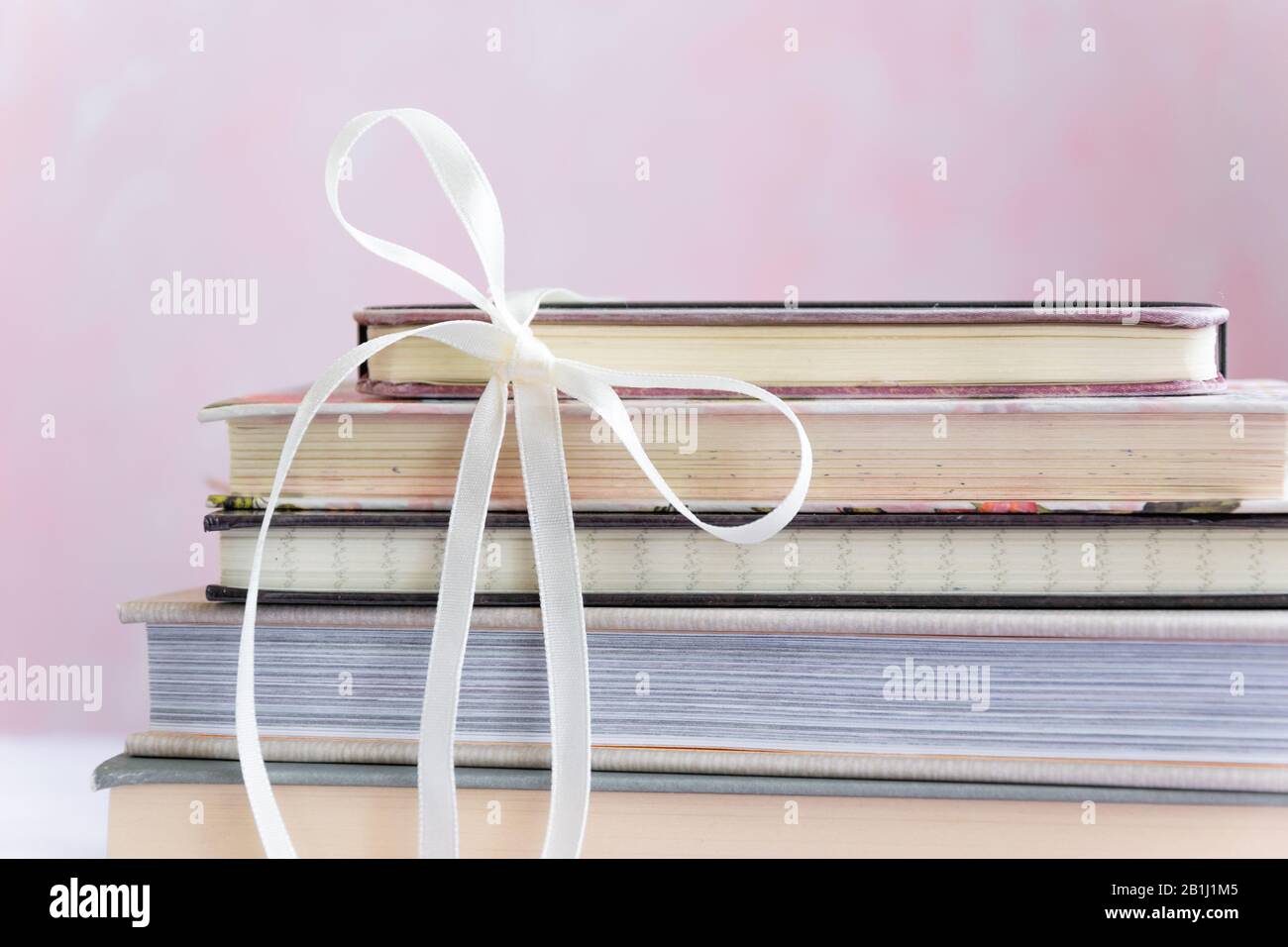 Stack of books tied with a bow Stock Photo - Alamy