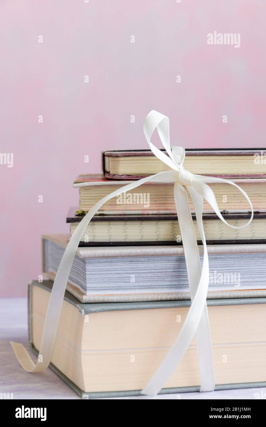 Stack of books tied with a bow Stock Photo - Alamy