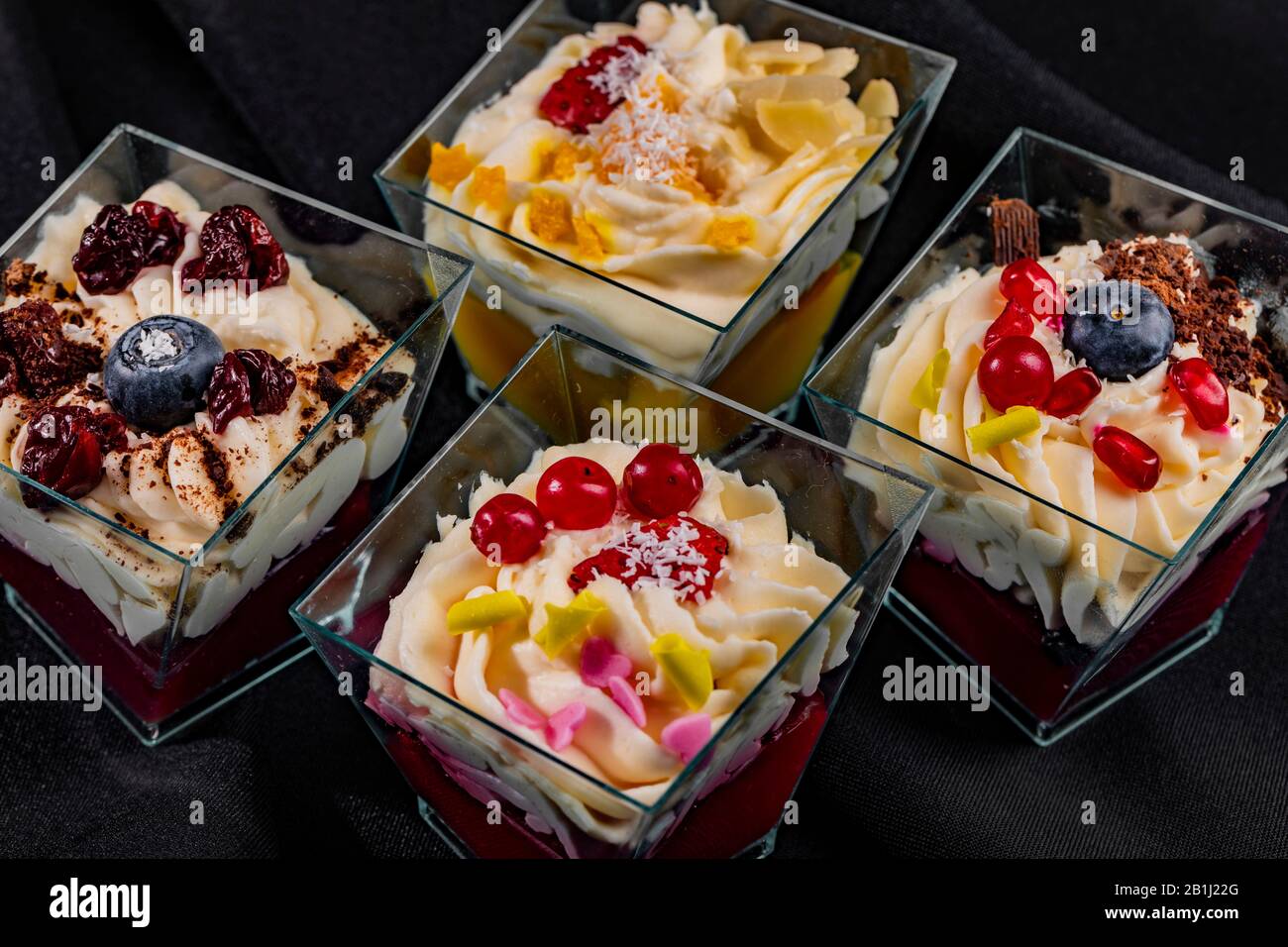 Four individual mixed desserts Stock Photo - Alamy