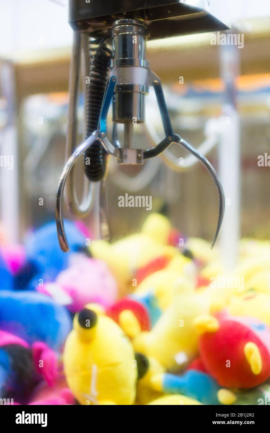 Mechanical claw game machine. Close-up view Stock Photo - Alamy