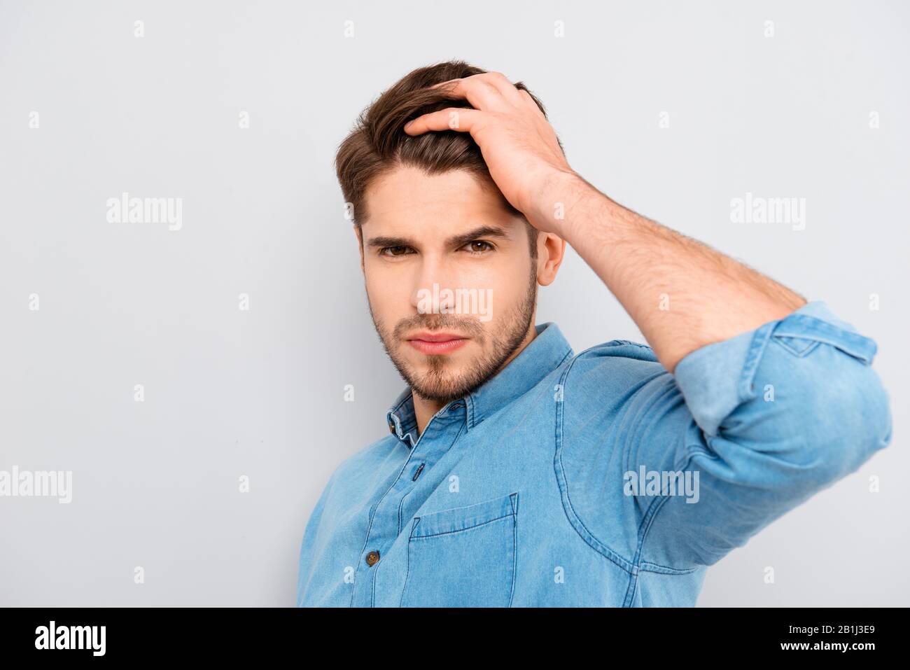 Portrait of handsome young guy combing his hair with fingers Stock ...