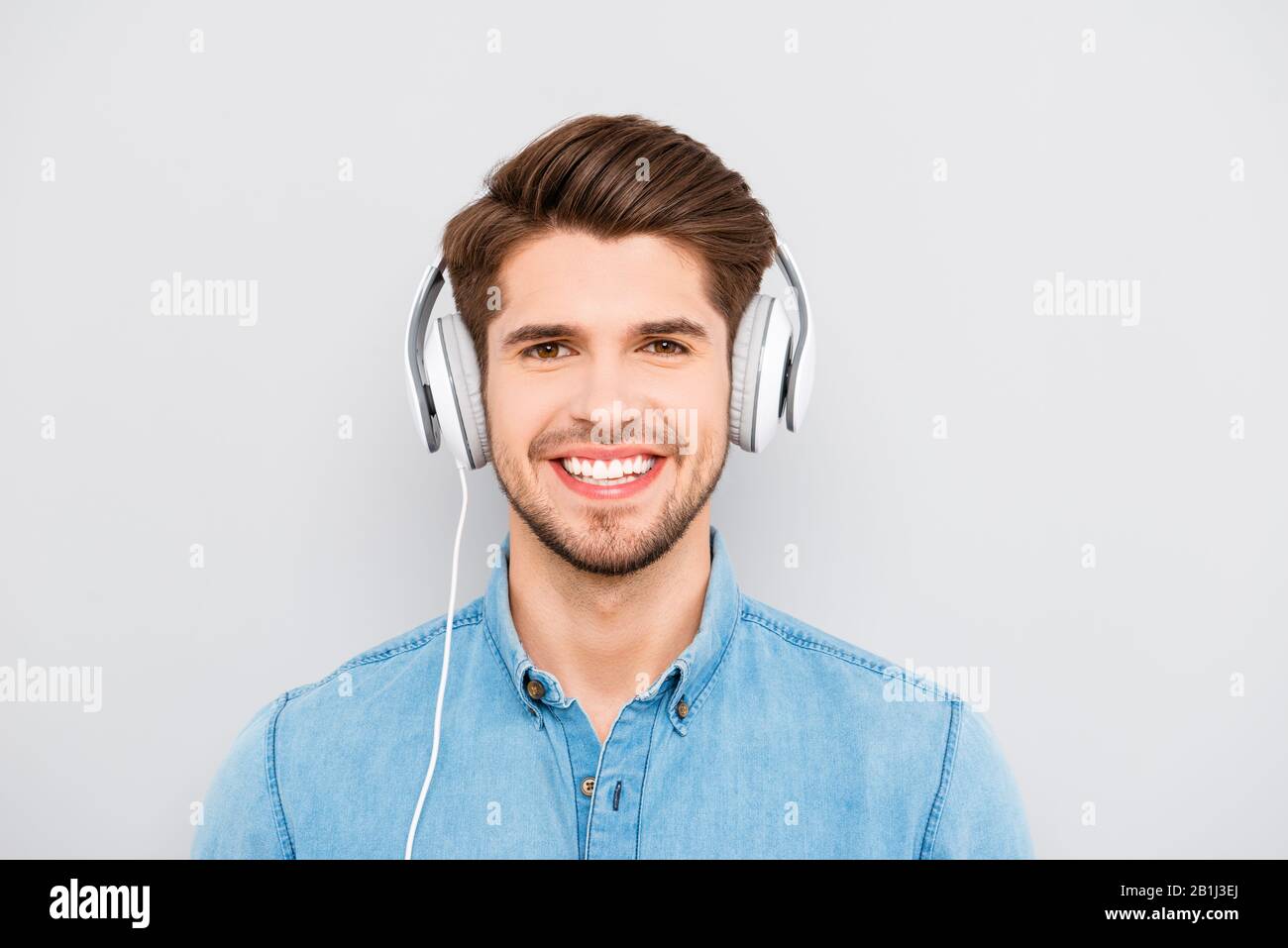 Cheerful relaxed music lover listening music in headphones Stock Photo ...
