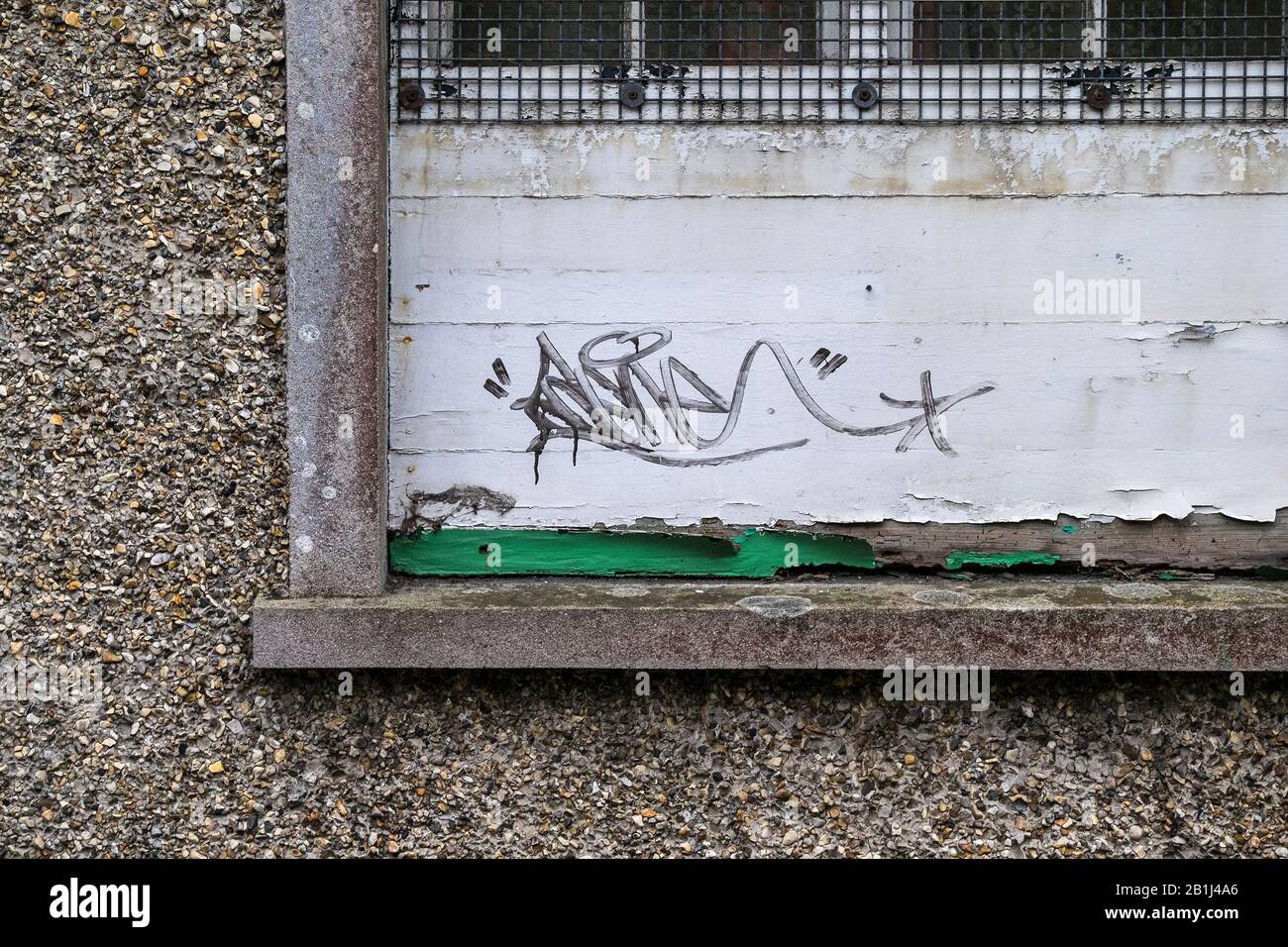 A graffiti tag on a boarded up window Stock Photo - Alamy