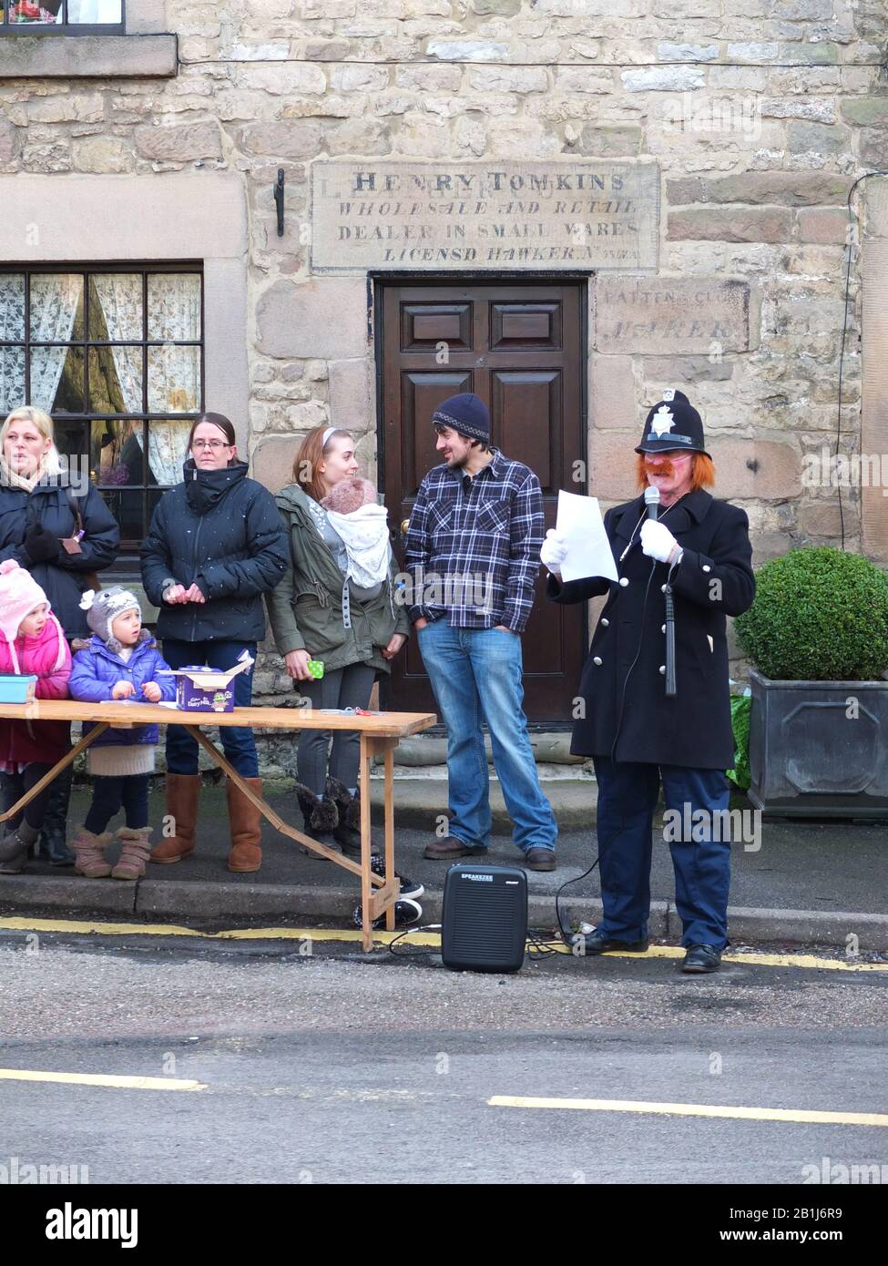 Comic policeman character in fancy dress reading out rules before start ...