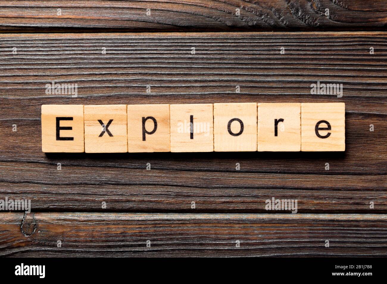 Explore word written on wood block. Explore text on wooden table for ...