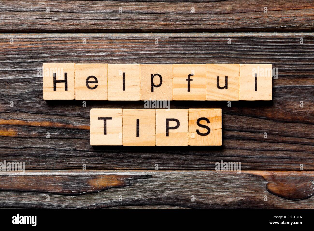 helpful tips word written on wood block. helpful tips text on table ...