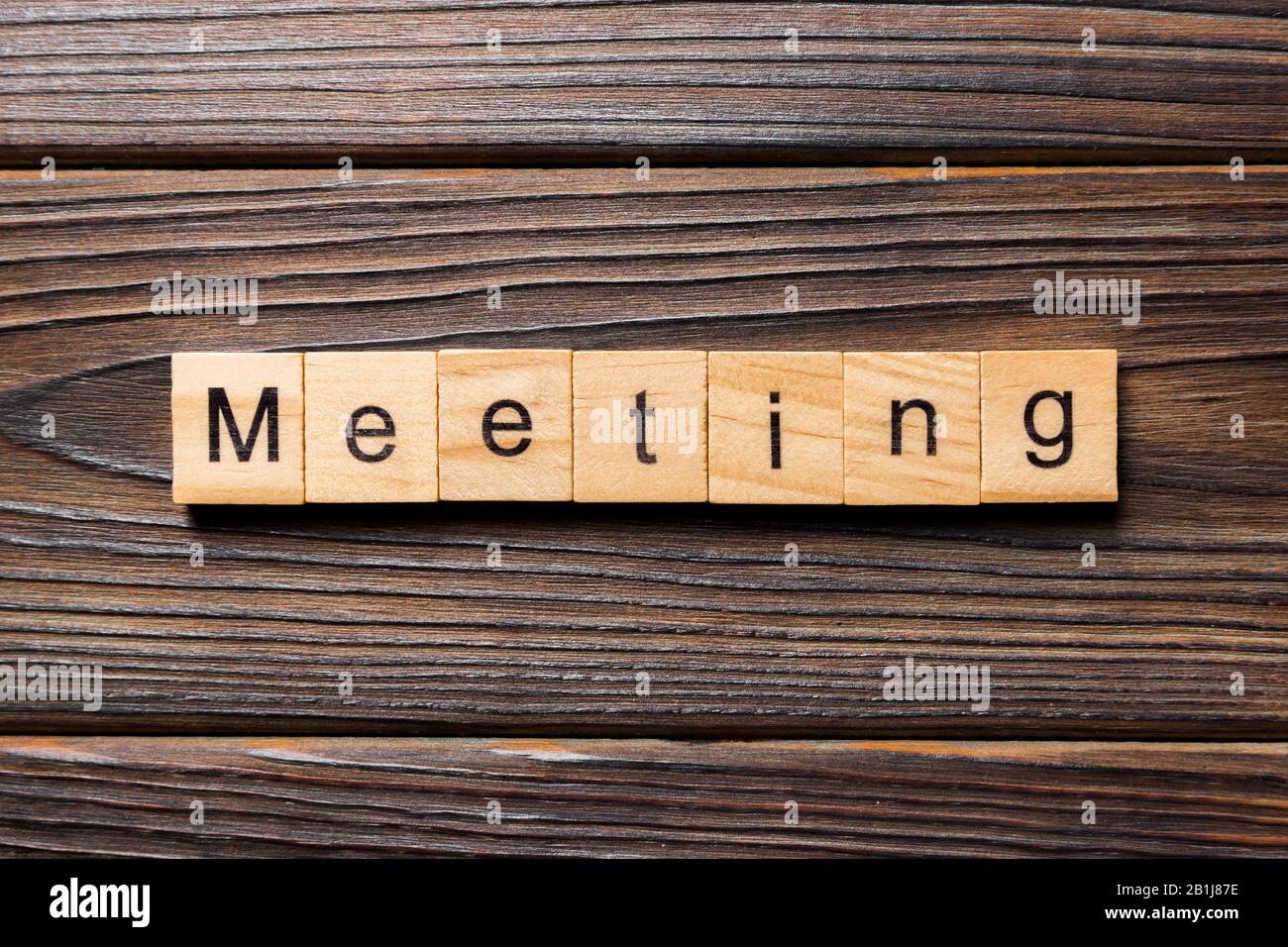 MEETING word written on wood block. MEETING text on wooden table for ...