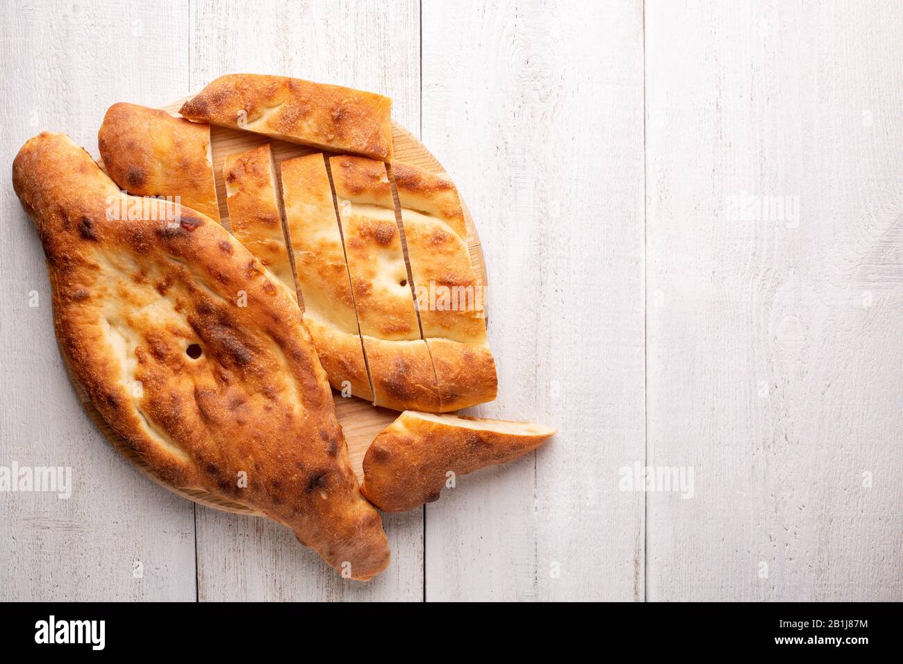 Traditional national Georgian Shoti bread. Whole and sliced bread lies ...