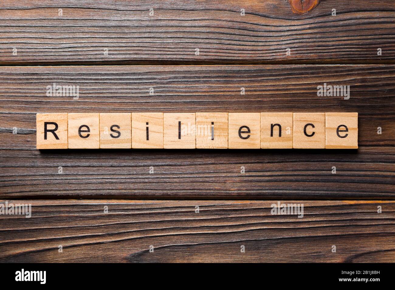 resilience word written on wood block. resilience text on table ...