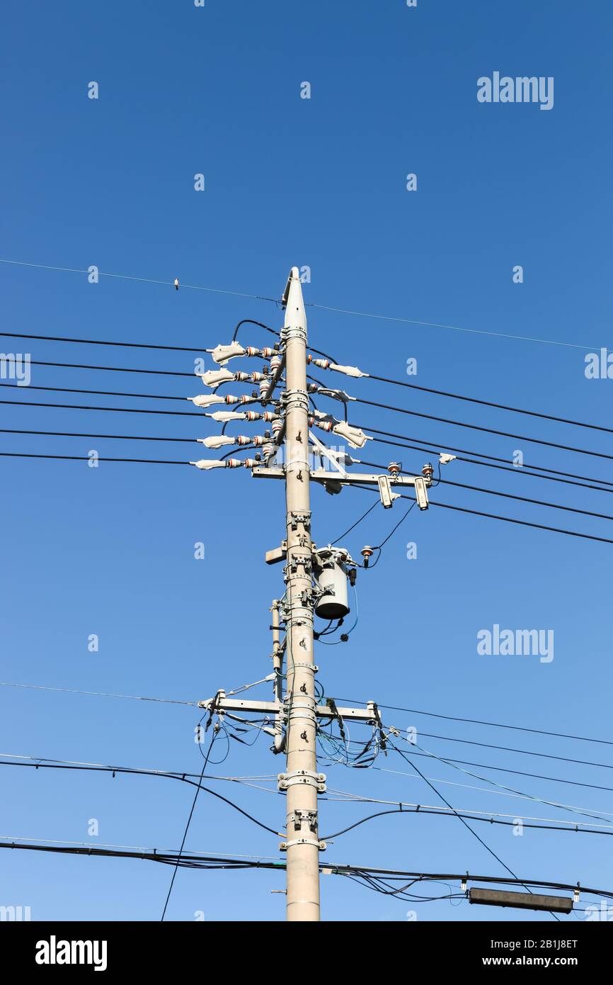 Electrical post with power line cables., against blue sky Stock Photo ...