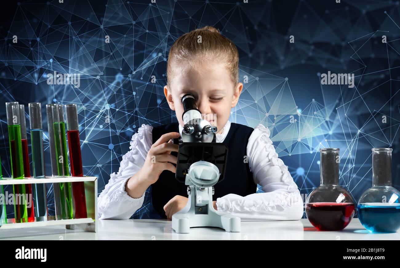 Little scientist looking through microscope Stock Photo - Alamy