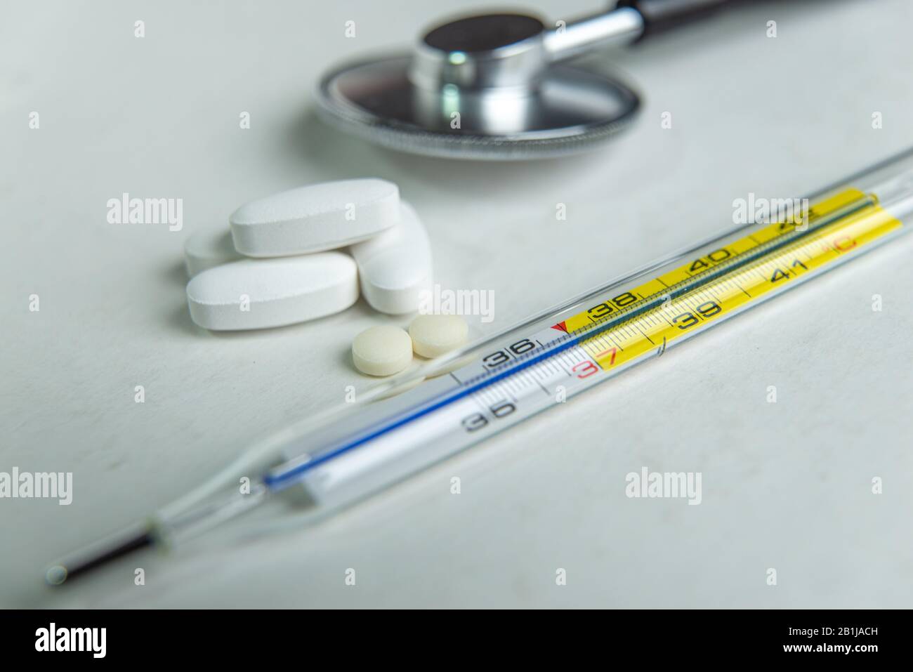 Thermometer and tablets for healthcare Stock Photo - Alamy
