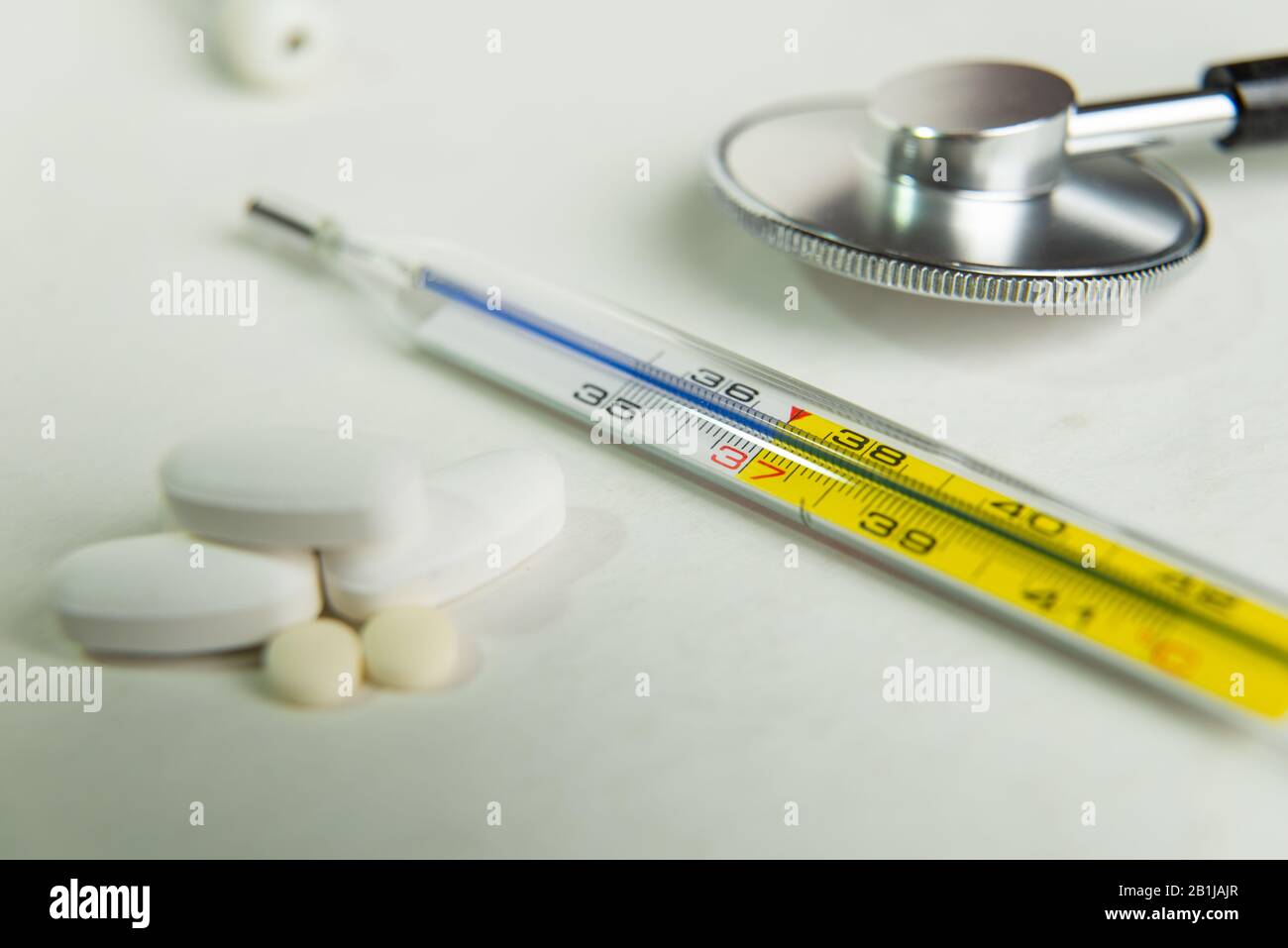 Thermometer and tablets for healthcare Stock Photo - Alamy