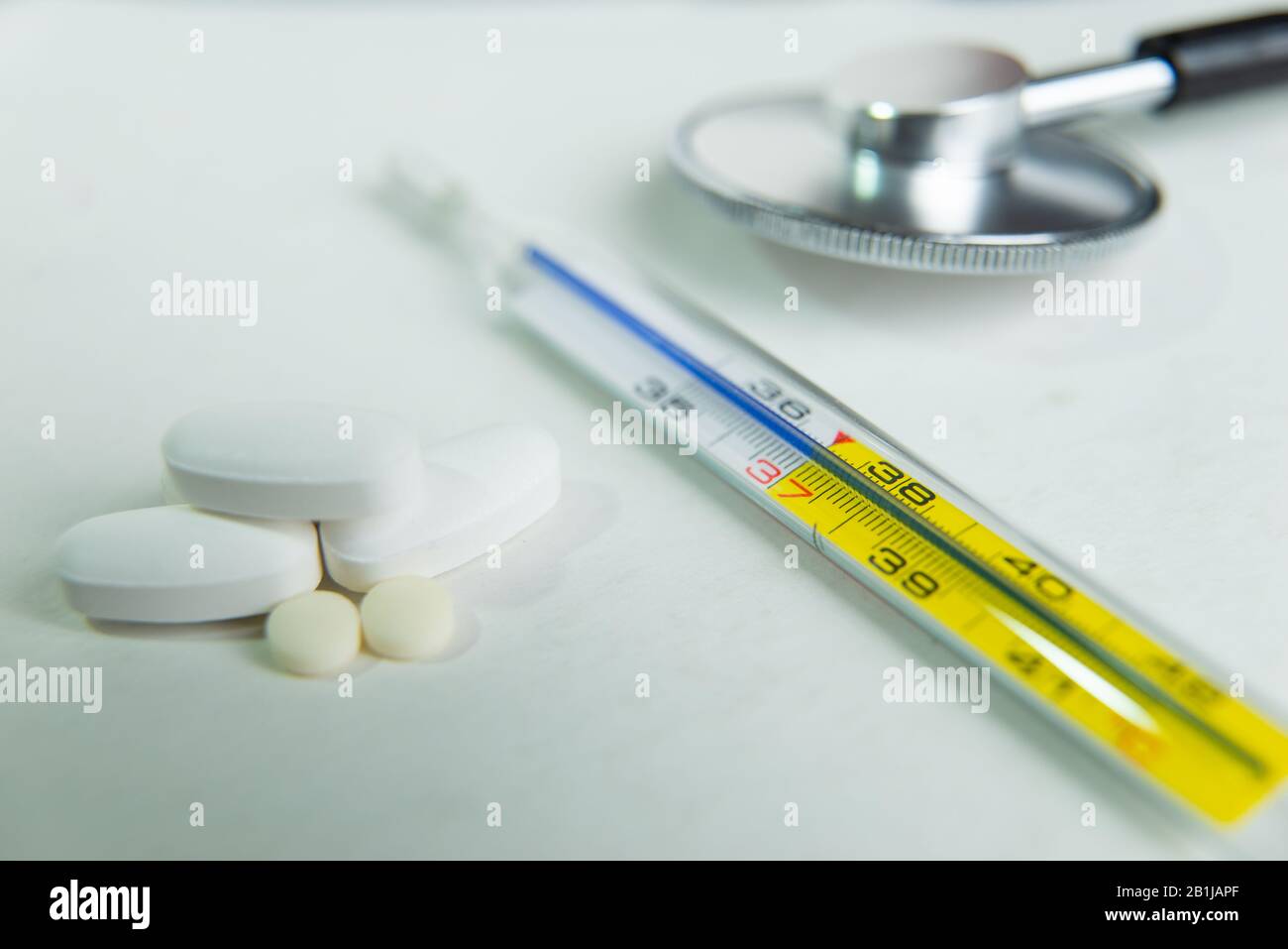 Thermometer and tablets for healthcare Stock Photo - Alamy