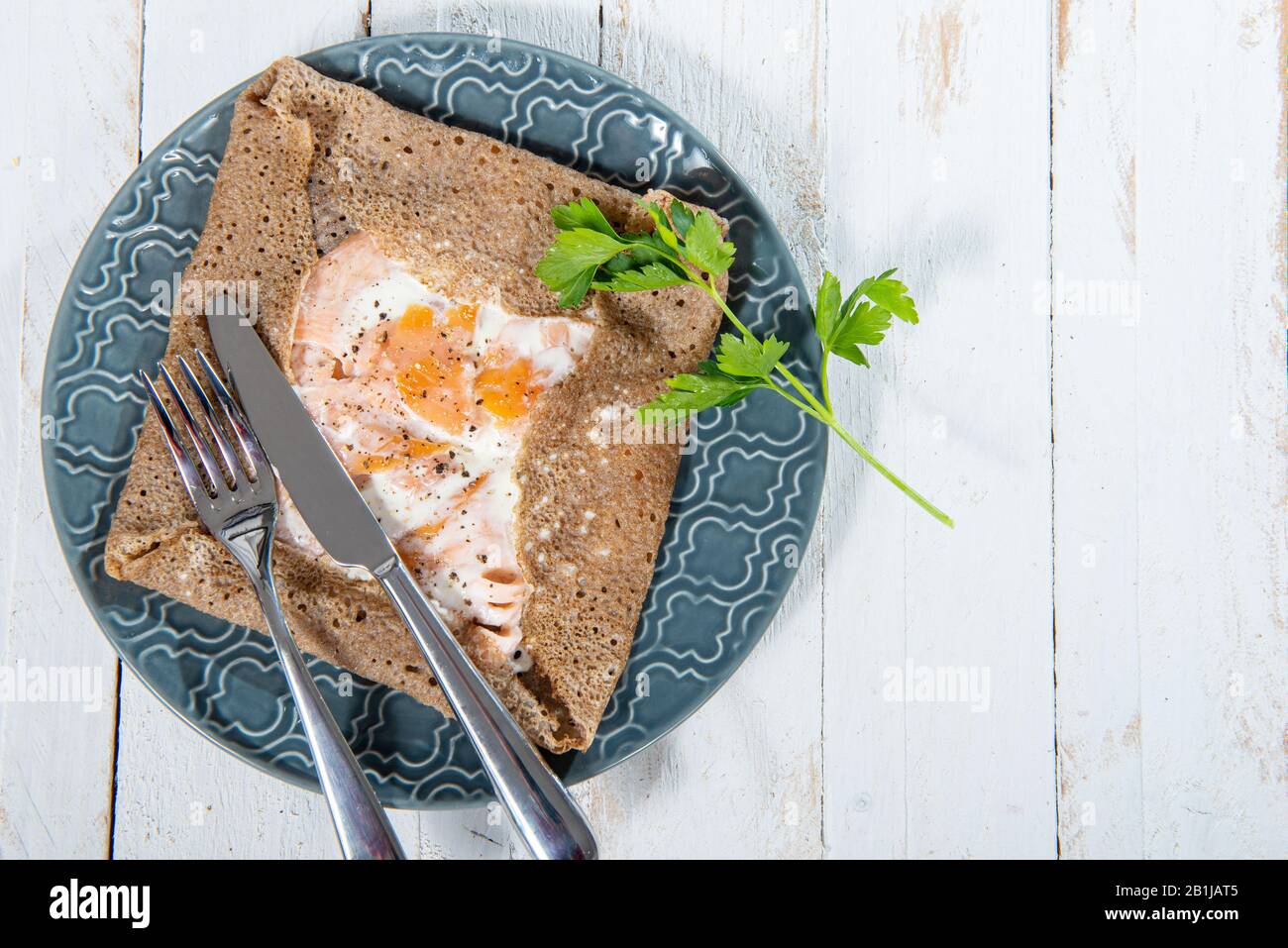 Breton crepe with egg in the blue plate Stock Photo - Alamy