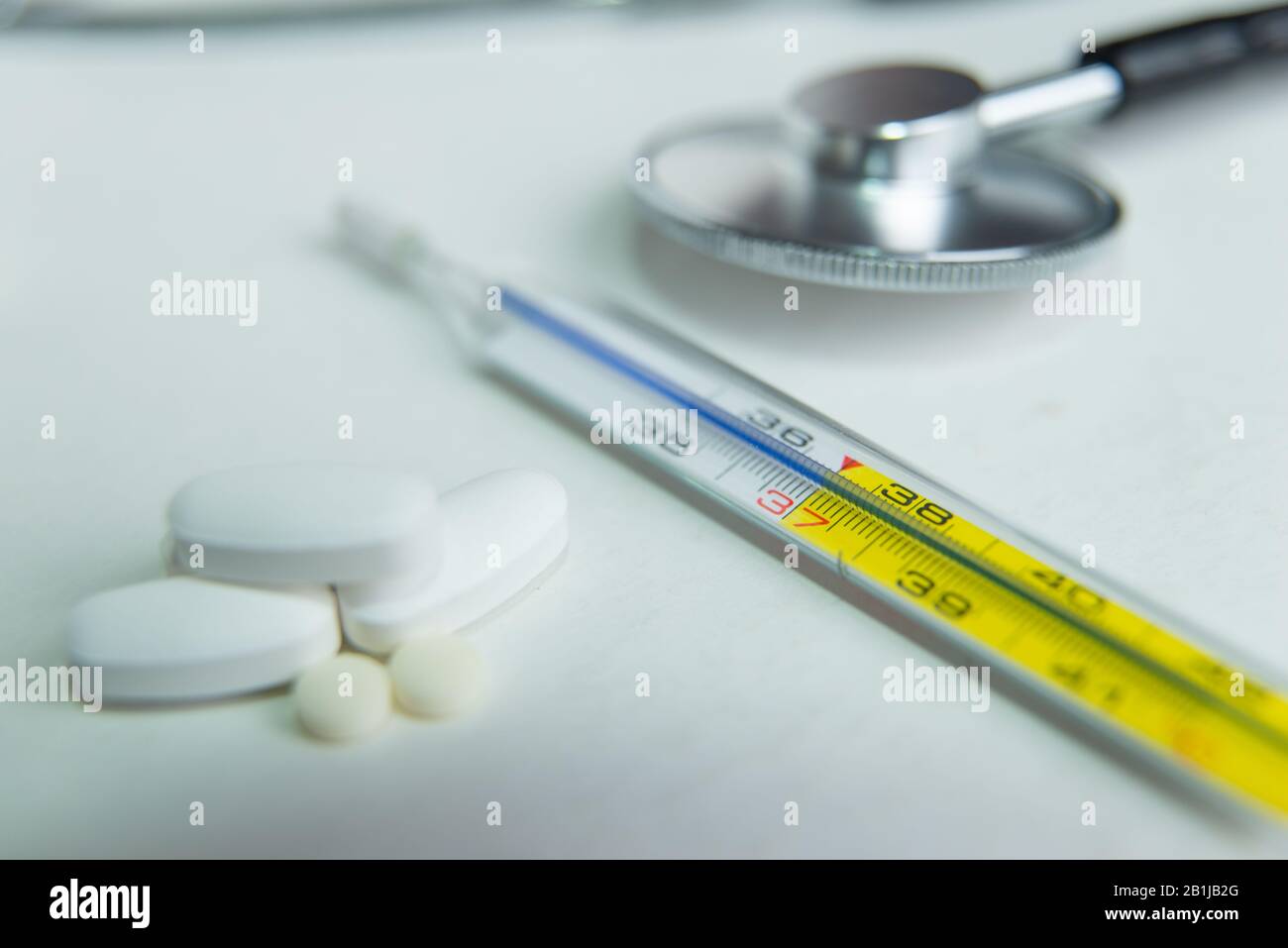 Thermometer and tablets for healthcare Stock Photo - Alamy