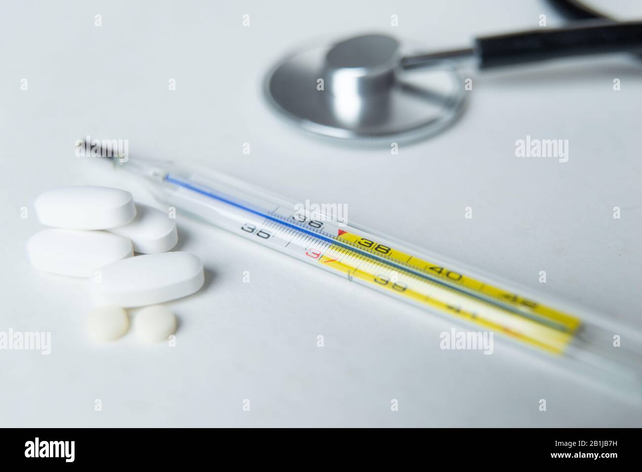 Thermometer and tablets for healthcare Stock Photo - Alamy